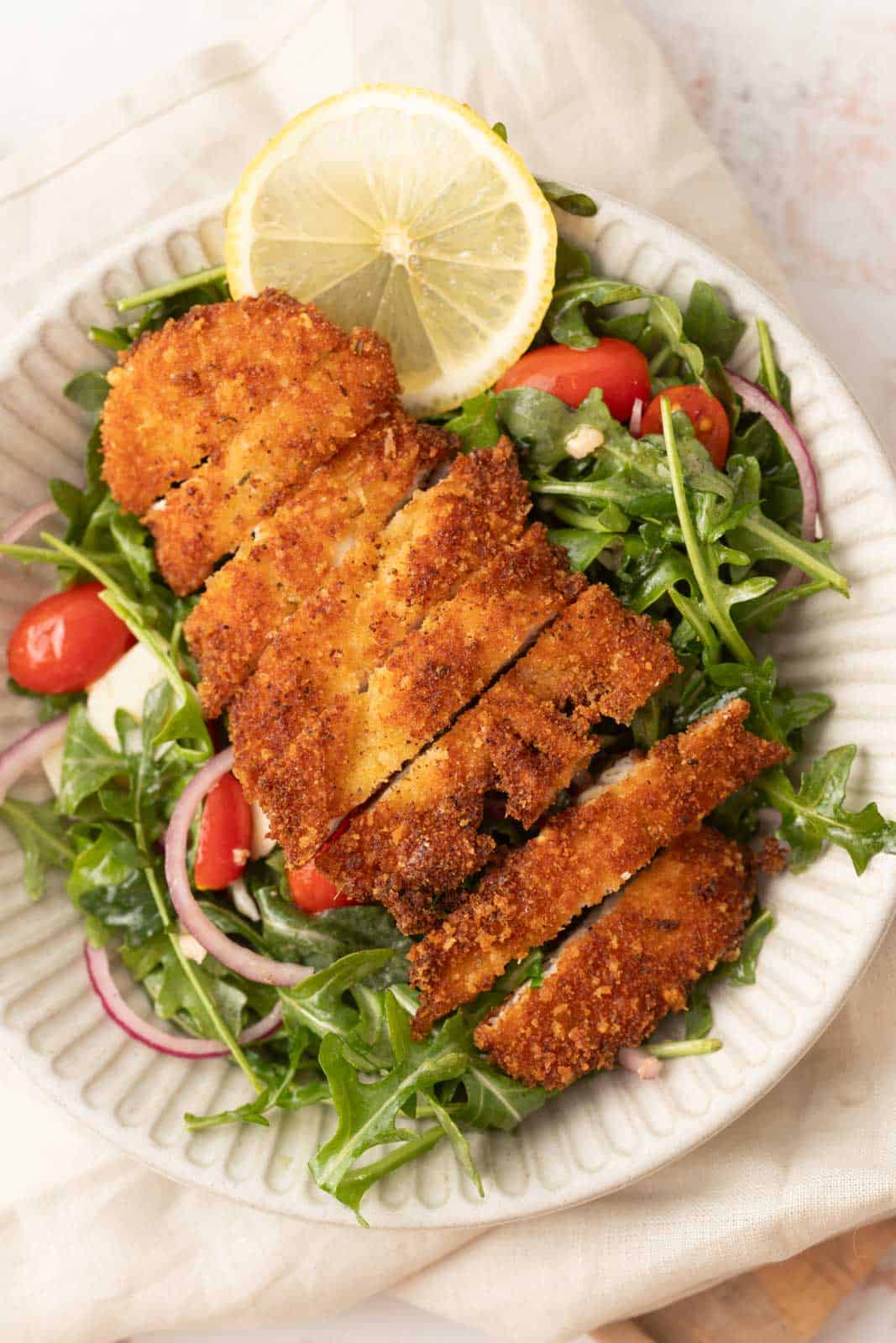 Crispy Chicken Milanese Salad with Arugula and Tomato - Seasoned and Salted